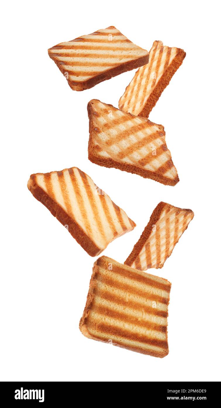 Slices of tasty toasted bread falling on white background Stock Photo ...