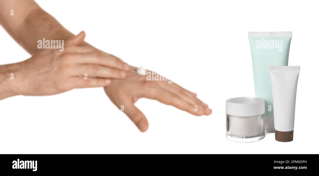 Man applying cream and containers of hand care cosmetic products on ...