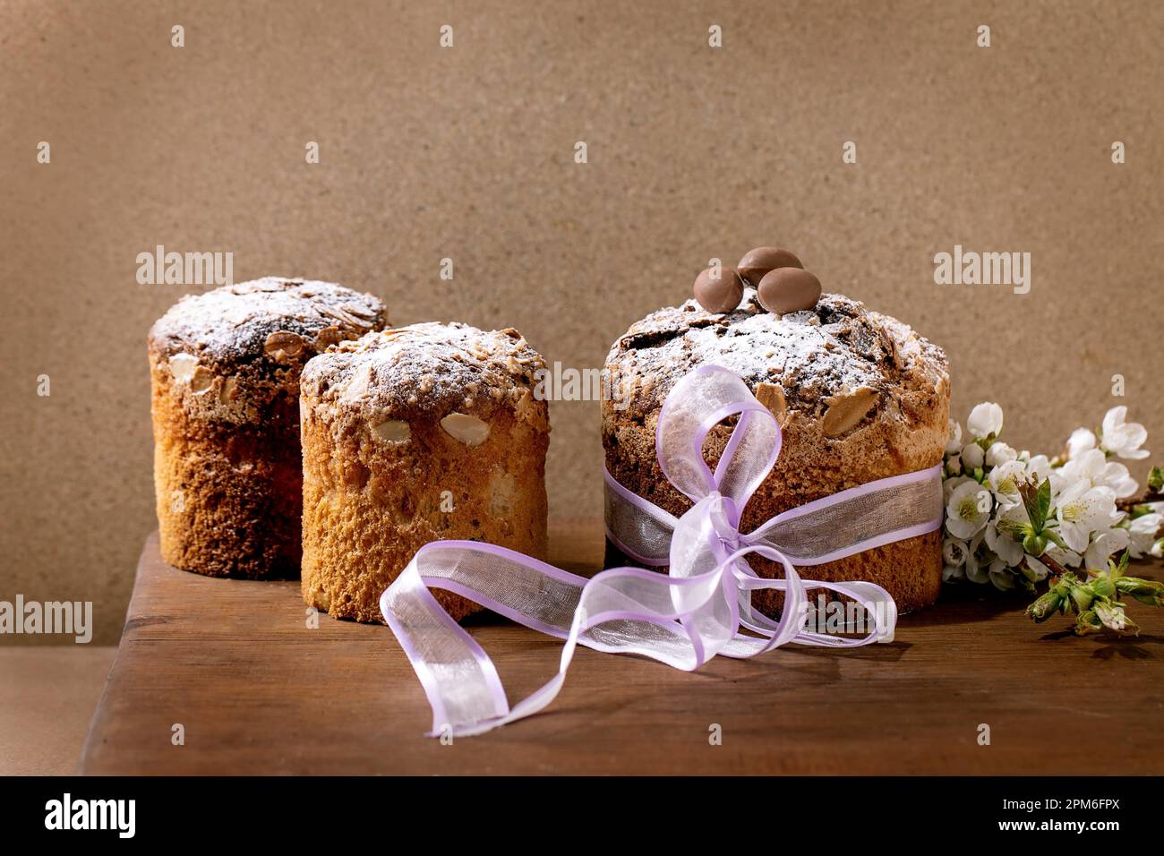 Homemade Italian traditional Easter panettone cakes in row, decorated ...