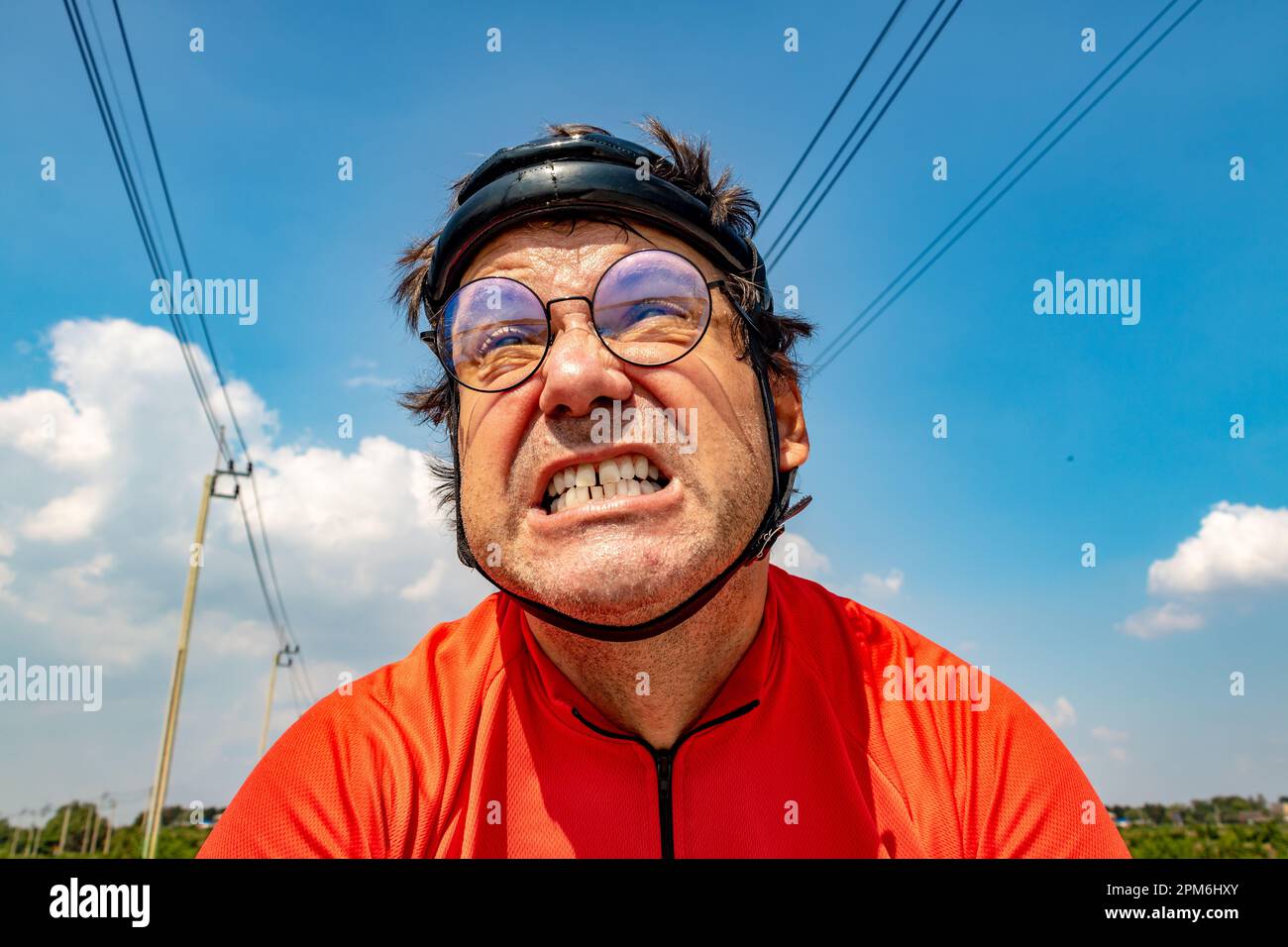A hard working cyclist is riding a bicycle under a blue sky Stock Photo ...