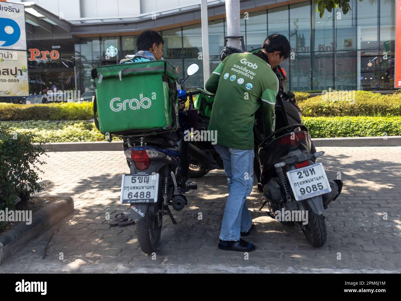 SAMUT PRAKAN, THAILAND, JAN 21 2023, A motorbikers of Grab delivery ...