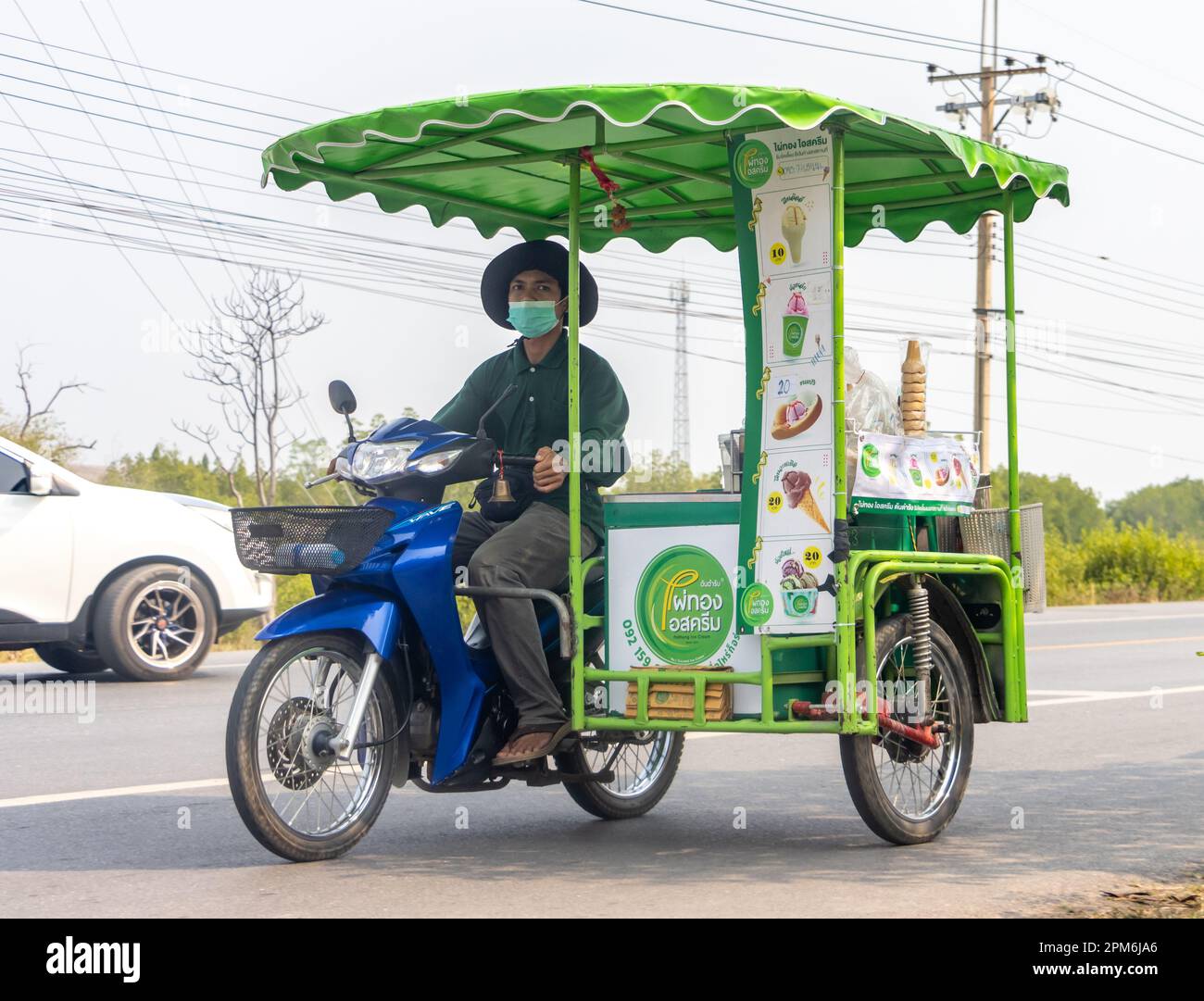 BANGKOK, THAILAND, MAR 11 2023, An ice cream vendor rides a three ...