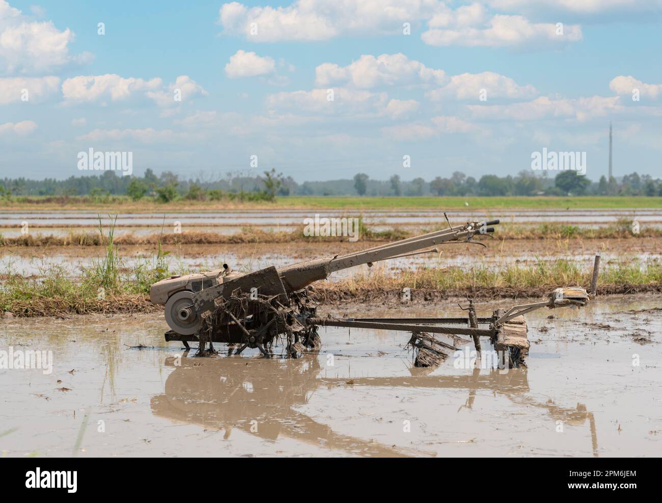 Wheel cultivator tractor park in the mud field. Farmer break working ...