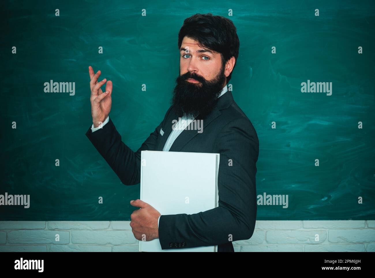 Bearded professor at school lesson at desks in classroom. Back to ...
