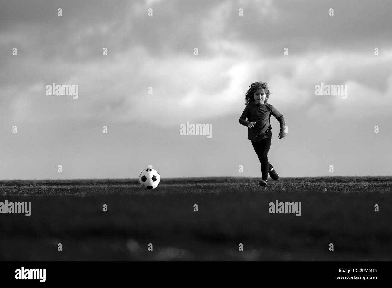 Soccer kid. Kids play football on summer stadium field. Little child ...