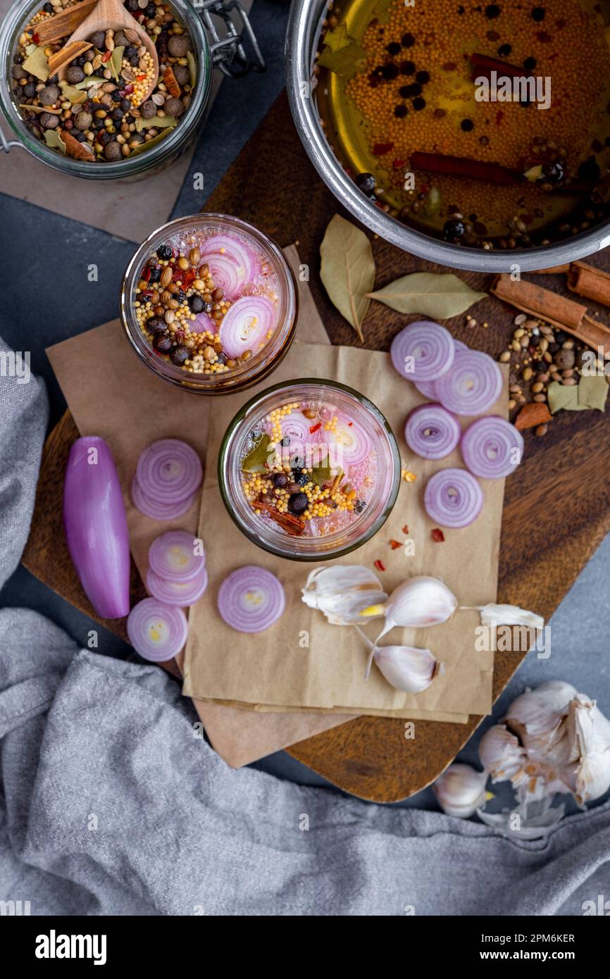 Sliced shallots being pickled in two glass jars, peeled and sliced ...