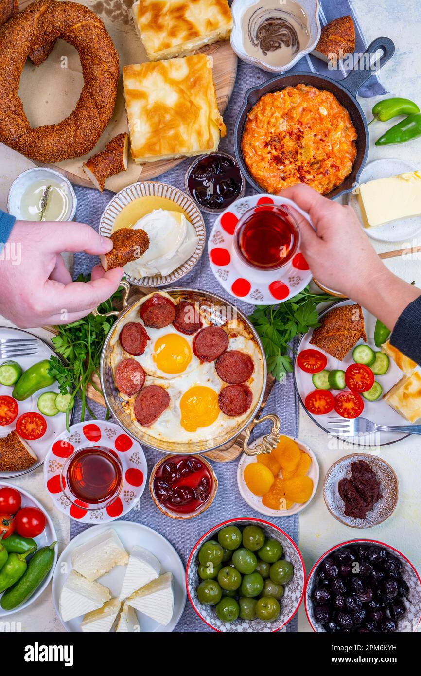 Traditional Turkish breakfast table. Eggs with sujuk, vegetables, jams ...