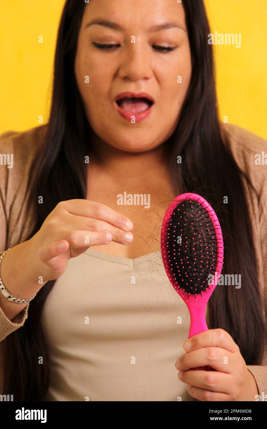 Latin adult woman with very long straight hair suffers from hair loss ...