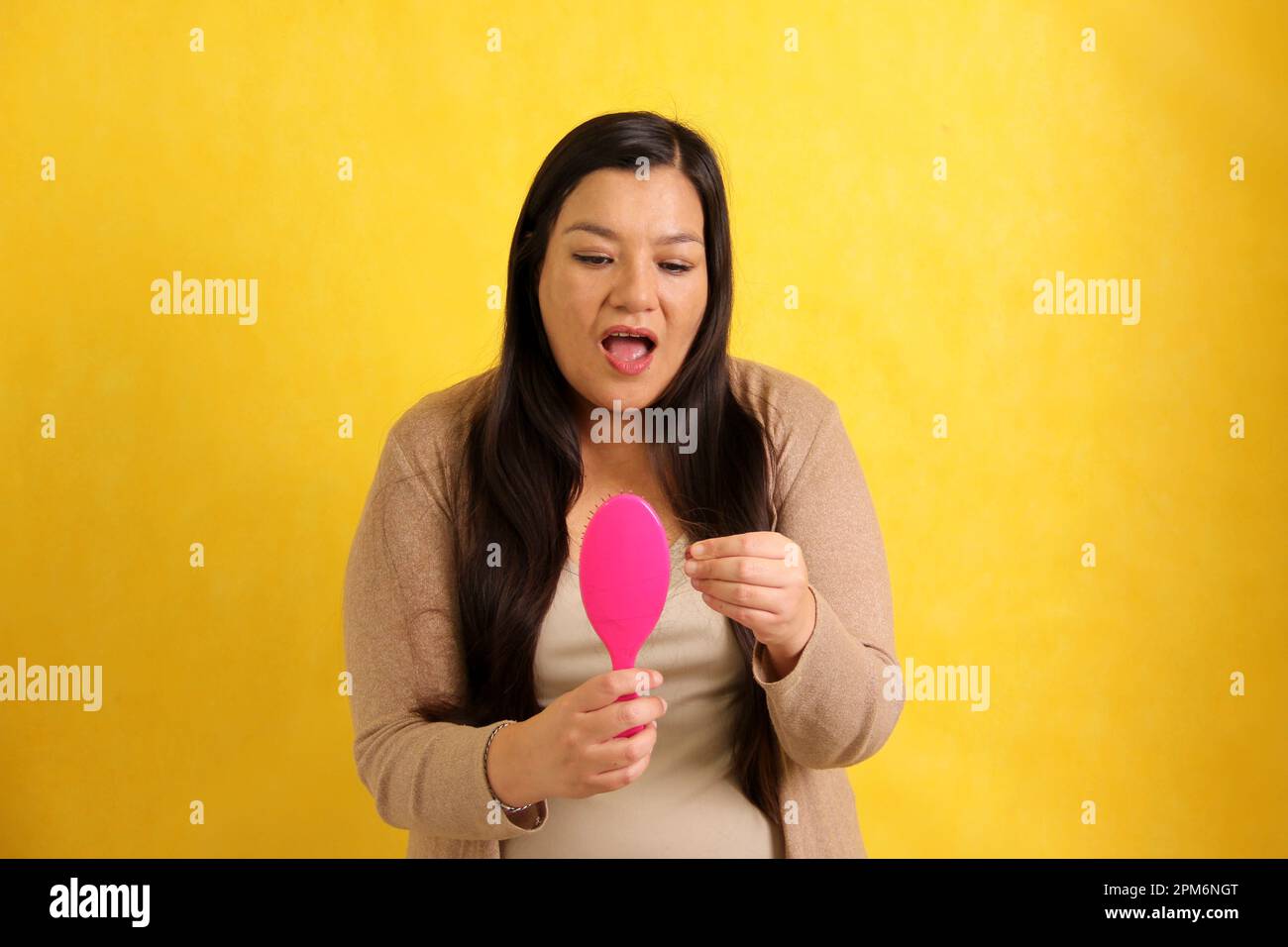 Latin Adult Woman With Very Long Straight Hair Suffers From Hair Loss Looking At The Brush How