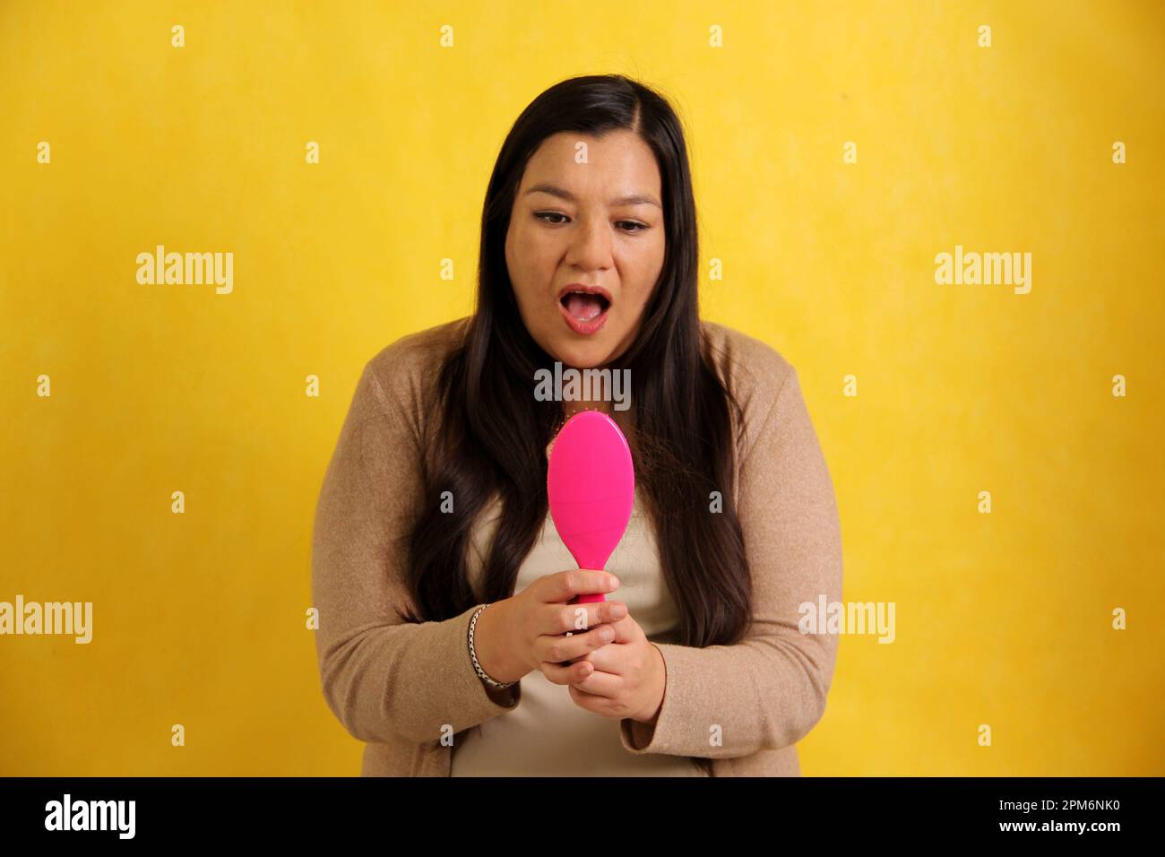 Latin Adult Woman With Very Long Straight Hair Suffers From Hair Loss Looking At The Brush How