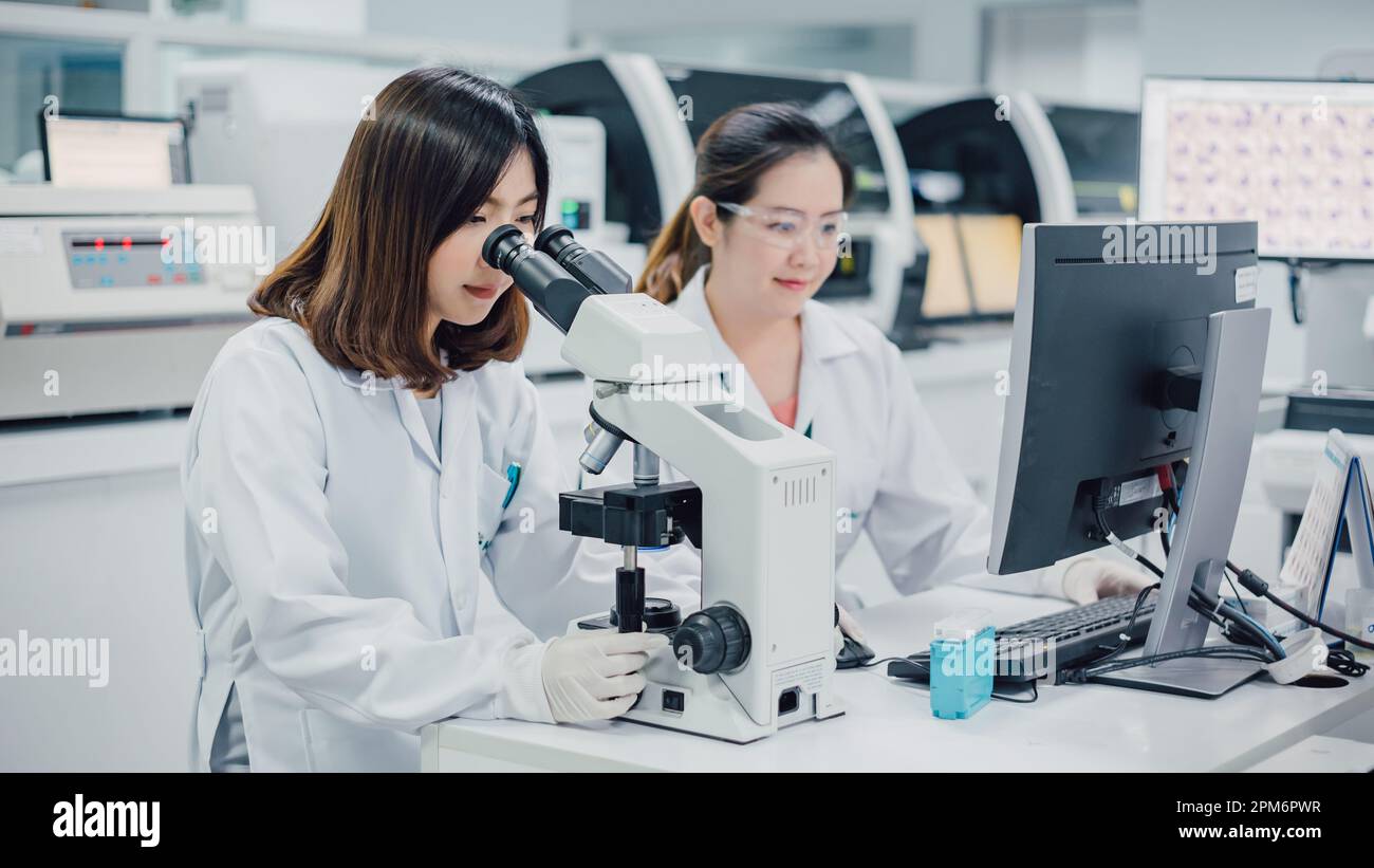 Team of medical research scientists collectively working on new research knowledge of sciences ...