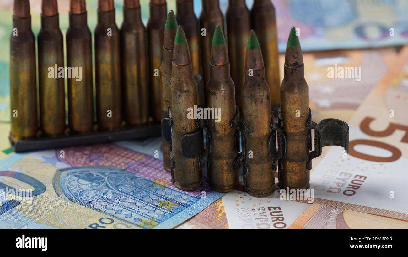 Ammunition from the gun on money bills. Bullets on Euros money ...