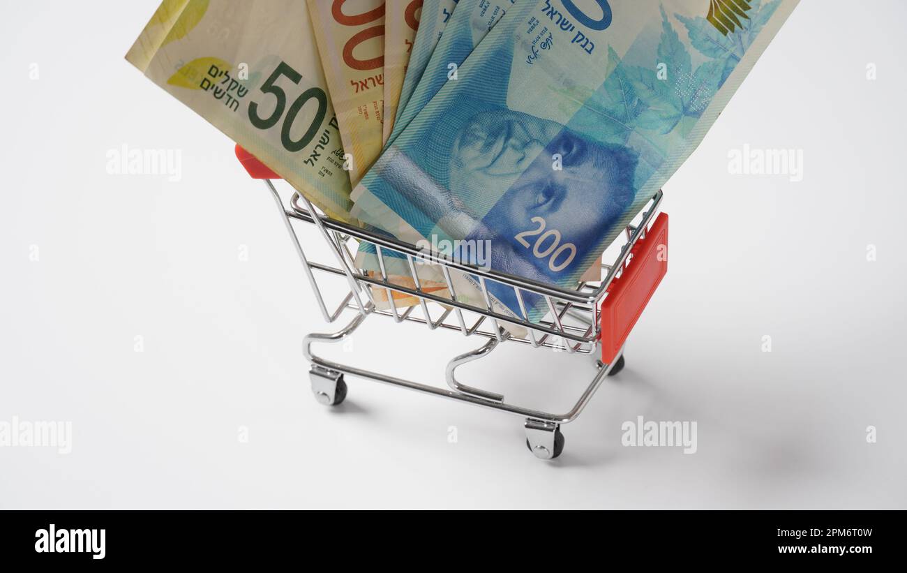 Shopping trolley with money. Israeli Shekel cash banknotes Stock Photo ...