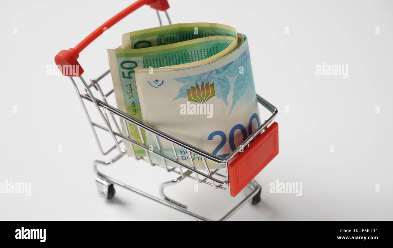 Shopping trolley with money. Israeli Shekel cash banknotes Stock Photo ...