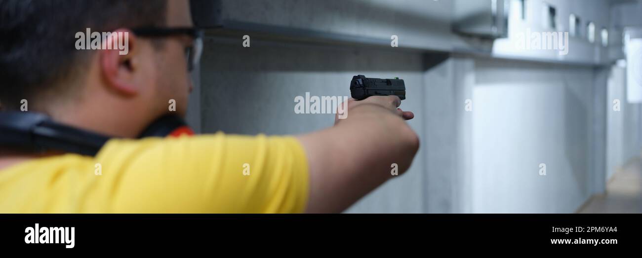 Man aiming pistol at target in shooting range Stock Photo - Alamy