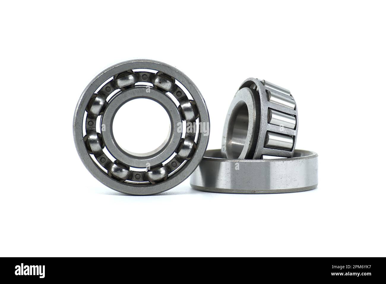 Ball bearings and tapered roller bearing isolated on white background ...