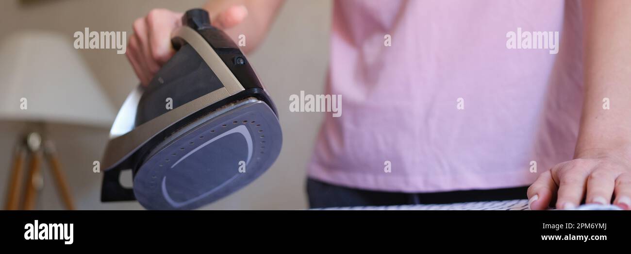 Housewife ironing bed linen on board using steam iron Stock Photo - Alamy