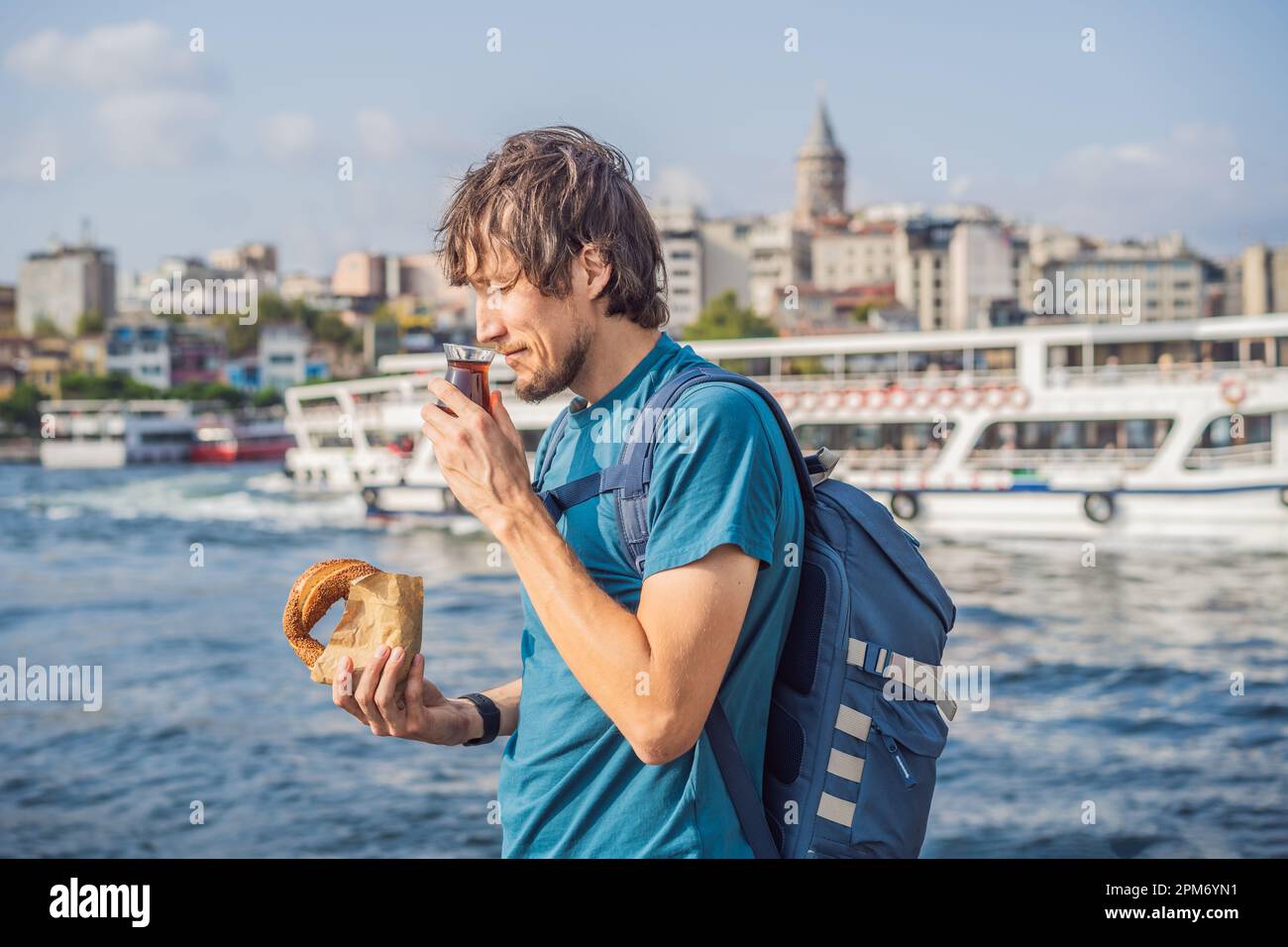 Man in Istanbul having breakfast with Simit and a glass of Turkish tea ...