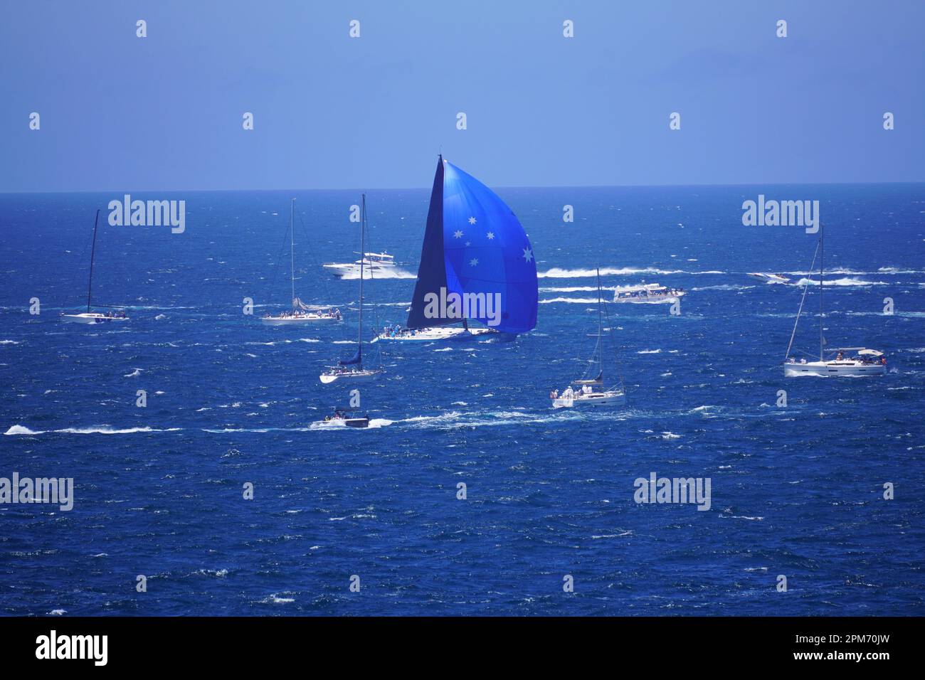 Yacht with Blue Sail bearing the Southern Cross surrounded by Spectator ...