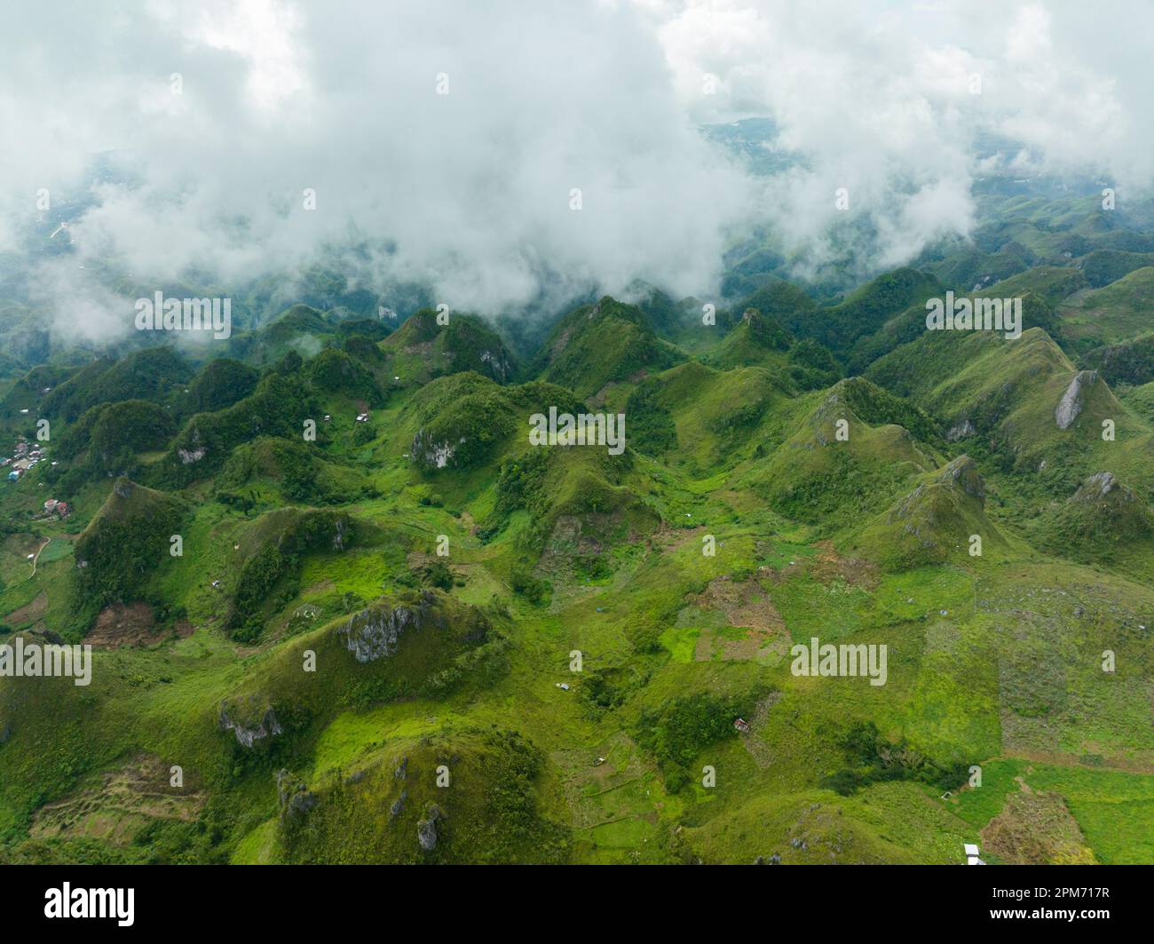 Top view of green mountains and hills covered with clouds. Osmena Peak ...