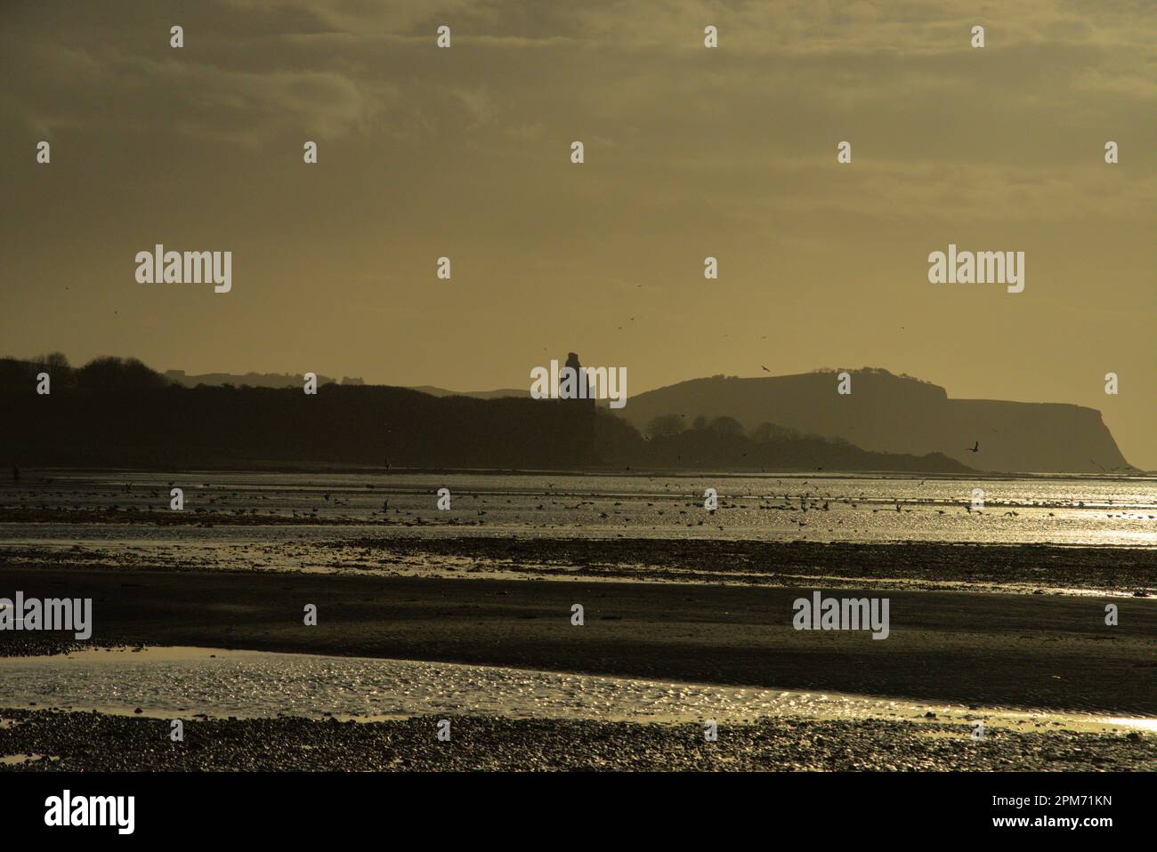Ayr beach at sunset, looking over towards Greenan castle Stock Photo ...