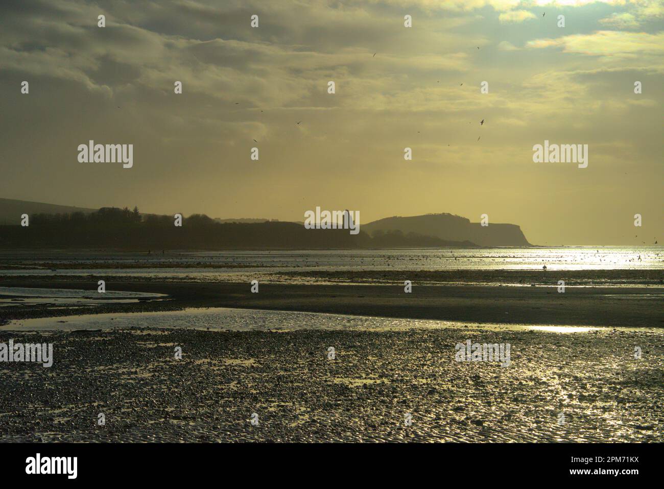 Ayr beach at sunset, looking over towards Greenan castle Stock Photo ...