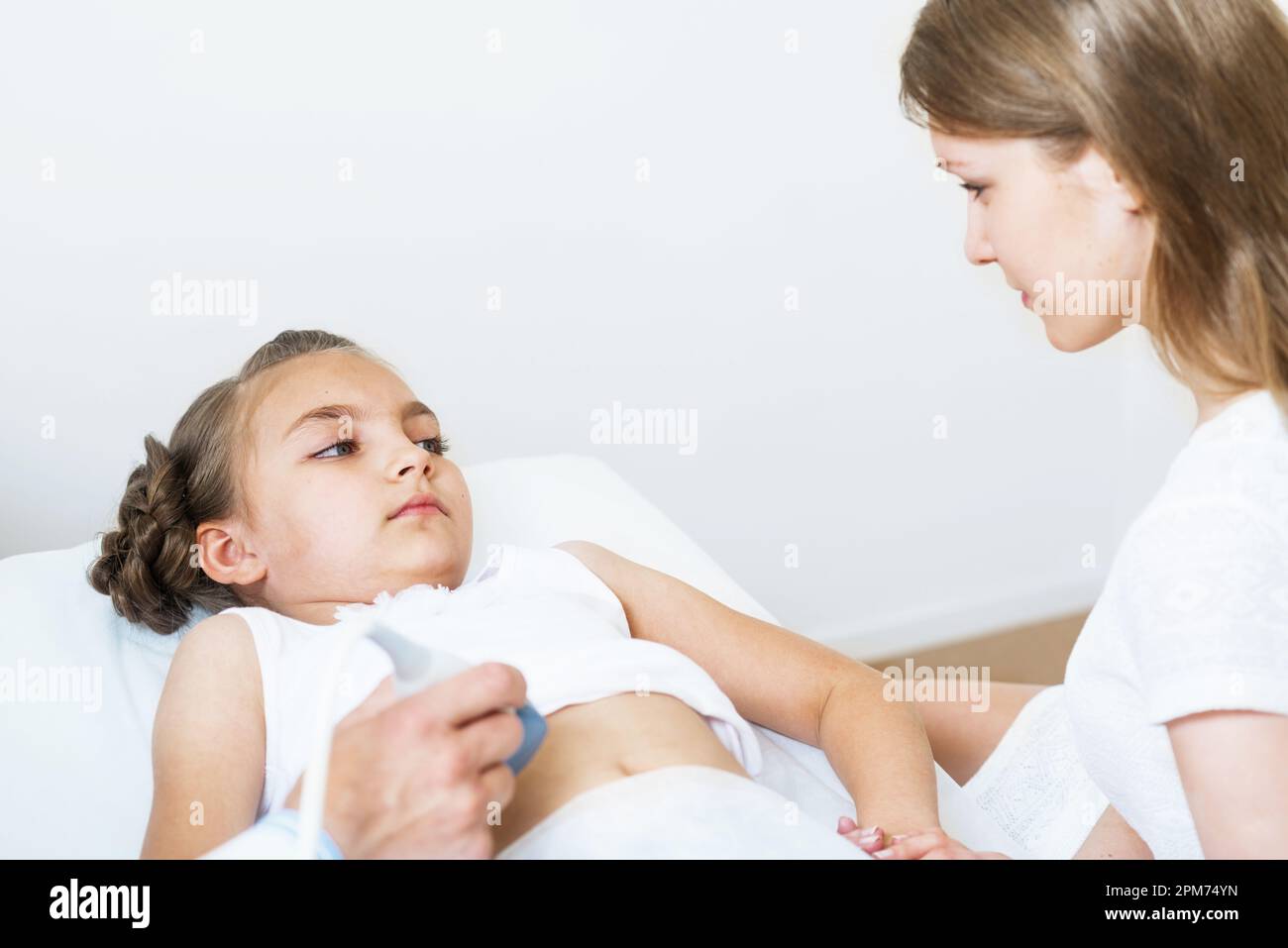 Medical exam little girl by ultrasound equipment Stock Photo - Alamy