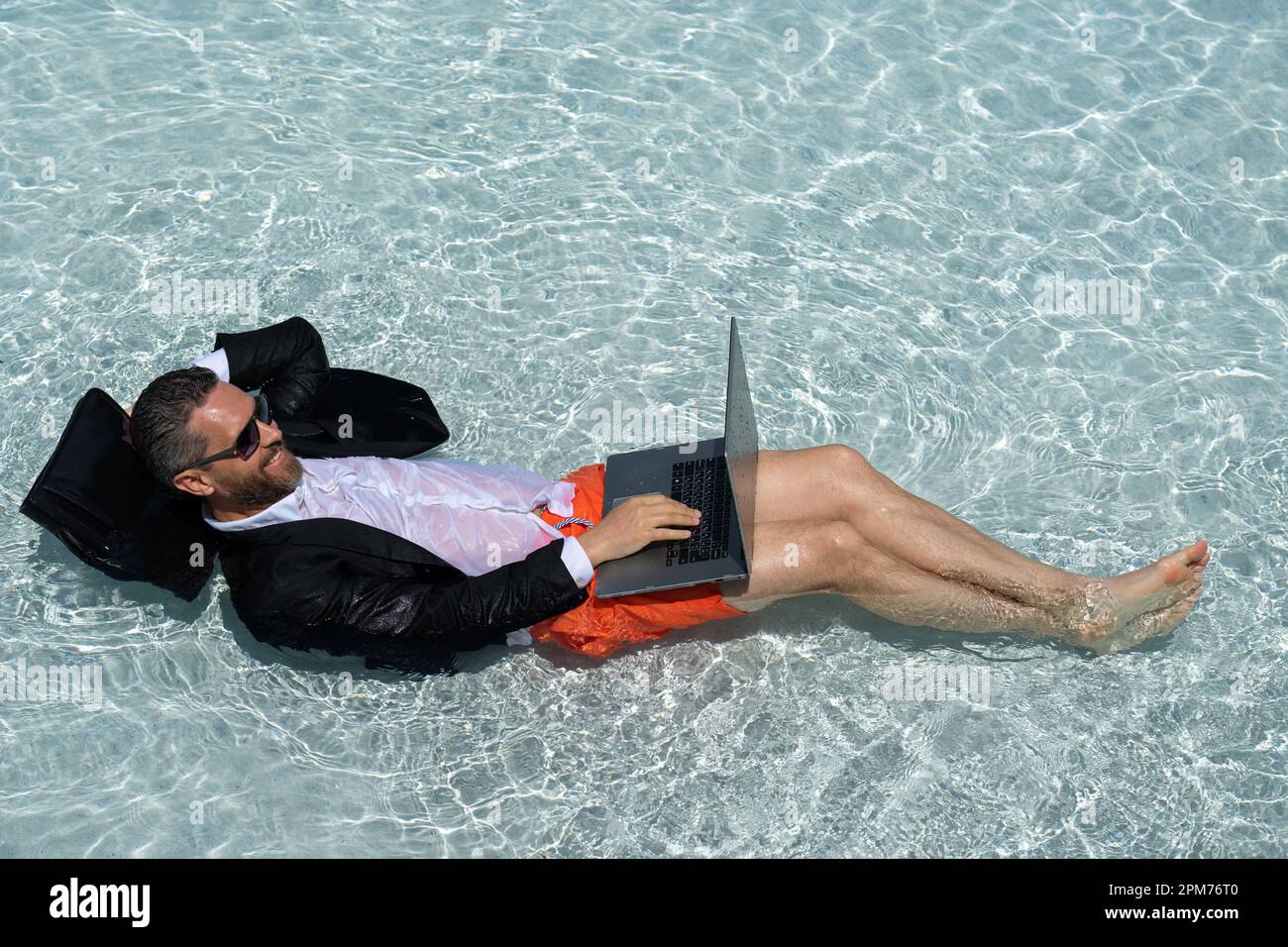 Successful businessman in suit in pool water. Summer vacations and ...