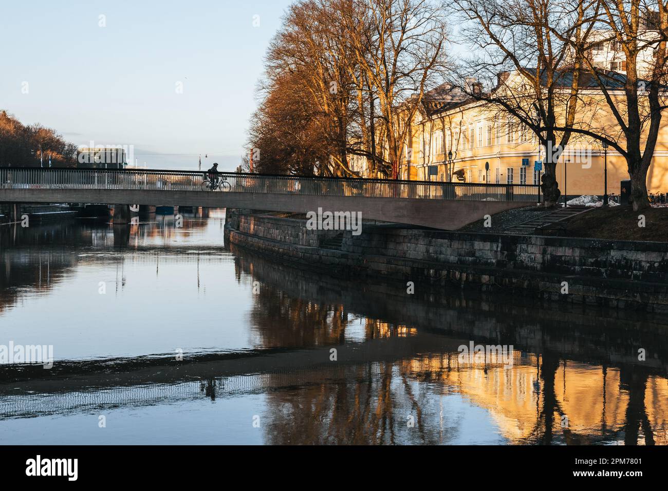 Cyclist on Kirjastosilta bridge in Turku, Finland in spring during ...