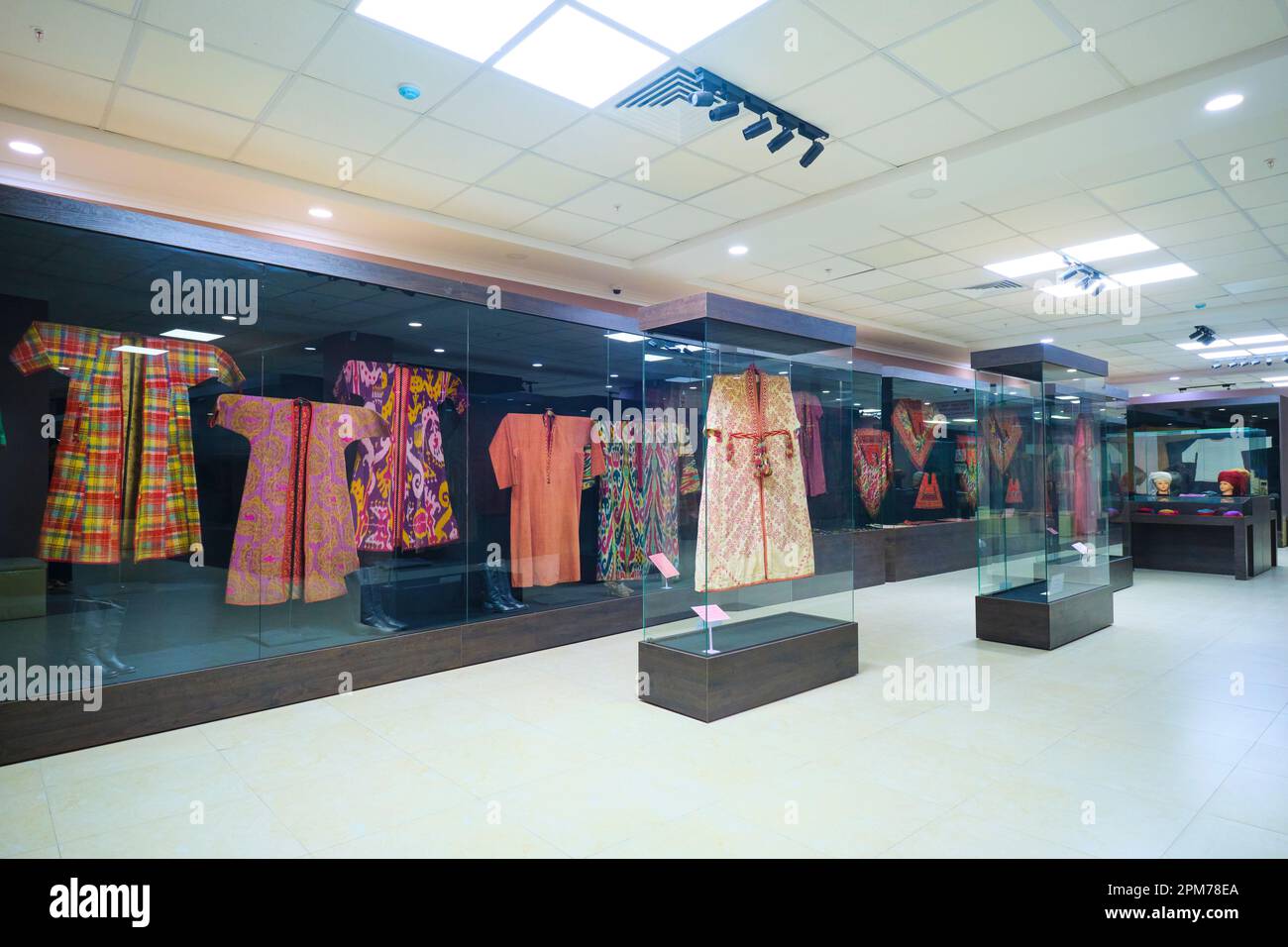 A display of many colorful, old, traditional chapans, robes. At the ...