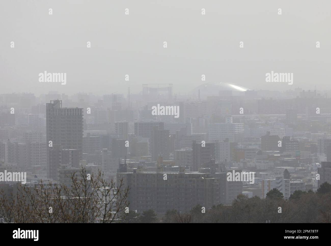 Visibility is low in the city of Sapporo due to yellow dust from China ...