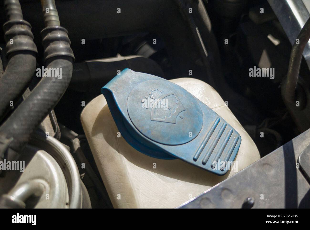 Filling water in car washer tank. Lid taken on Stock Photo - Alamy