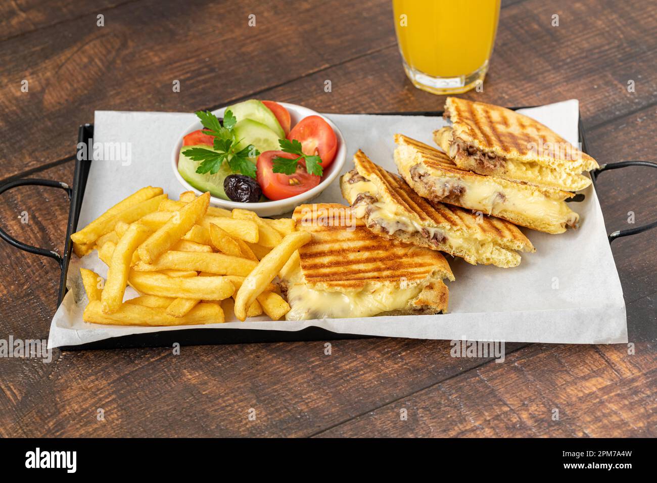 Turkish toast with roasted meat served with olives, cucumbers and ...