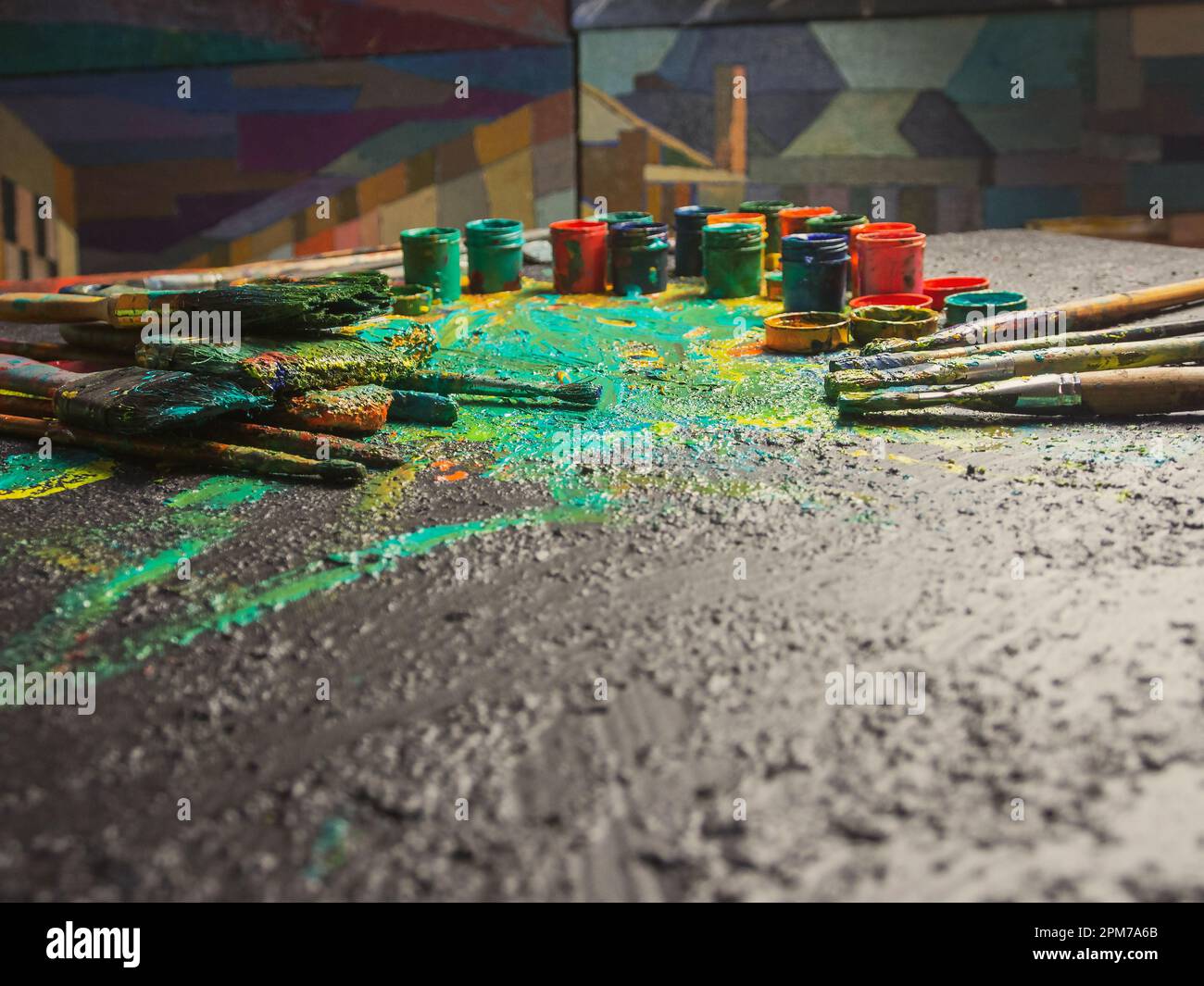 Acrylic colors, palette and brushes in the art studio. Colorful, multi ...