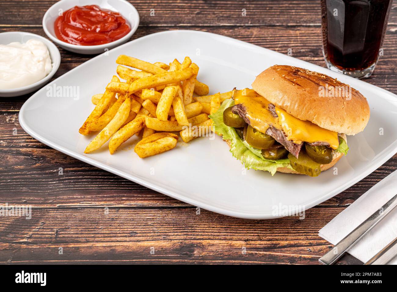 Delicious beef burger with french fries, onion rings and sauces Stock ...