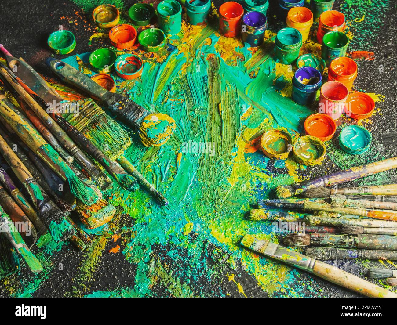 Acrylic colors, palette and brushes in the art studio. Colorful, multi ...