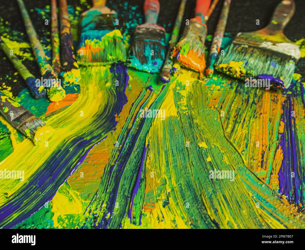 Acrylic colors, palette and brushes in the art studio. Colorful, multi ...