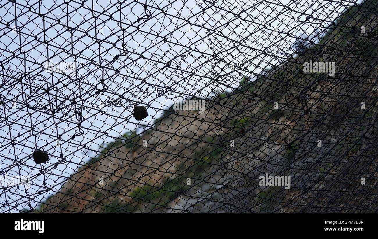 Falling rock stone rockfall slide protective fence barrier. Metallic ...