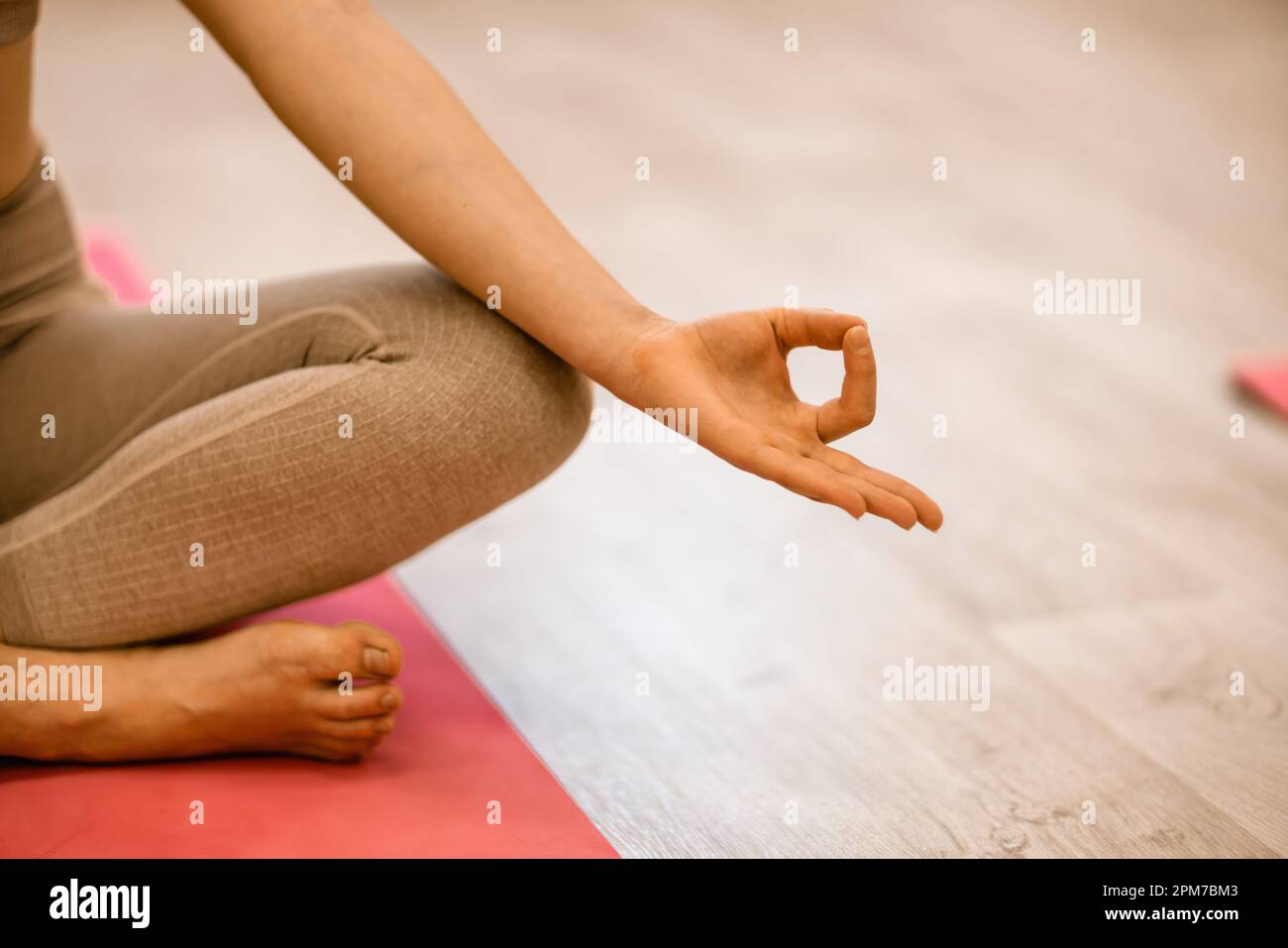 Girl does yoga. Young woman practices asanas on a beige one-ton ...