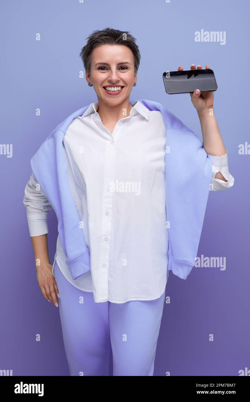 authentic young woman with short haircut showing smartphone mockup ...