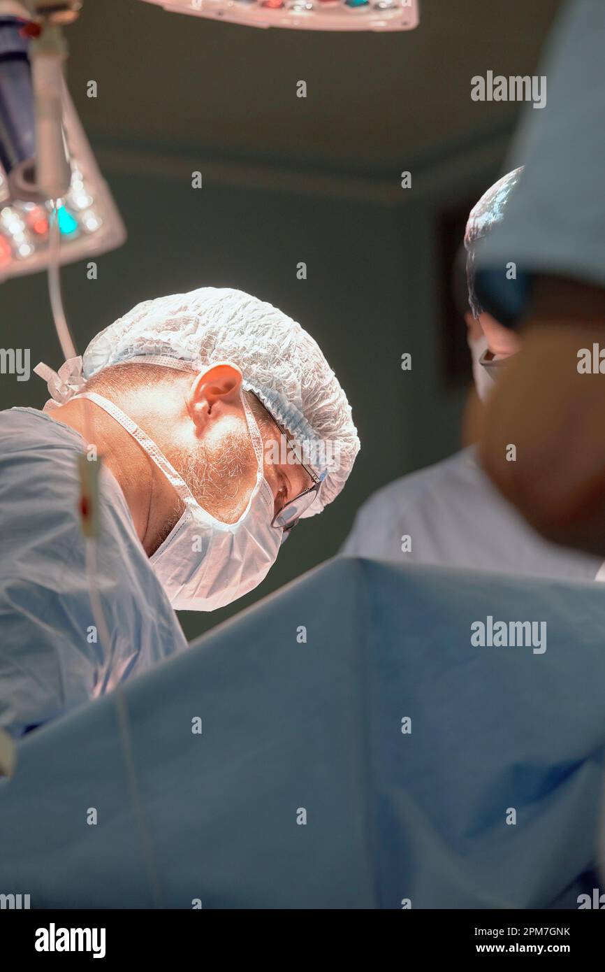 Surgeon face in operating room, stressful operation, surgeon performs ...