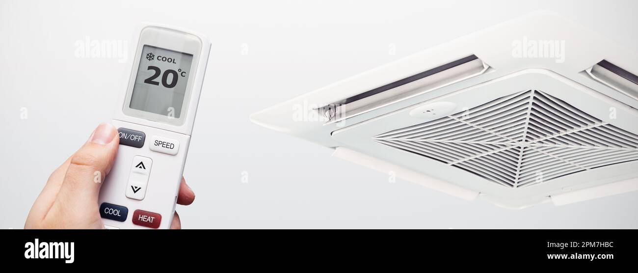 Air conditioner at home, hand with remote control. Air climate conept ...