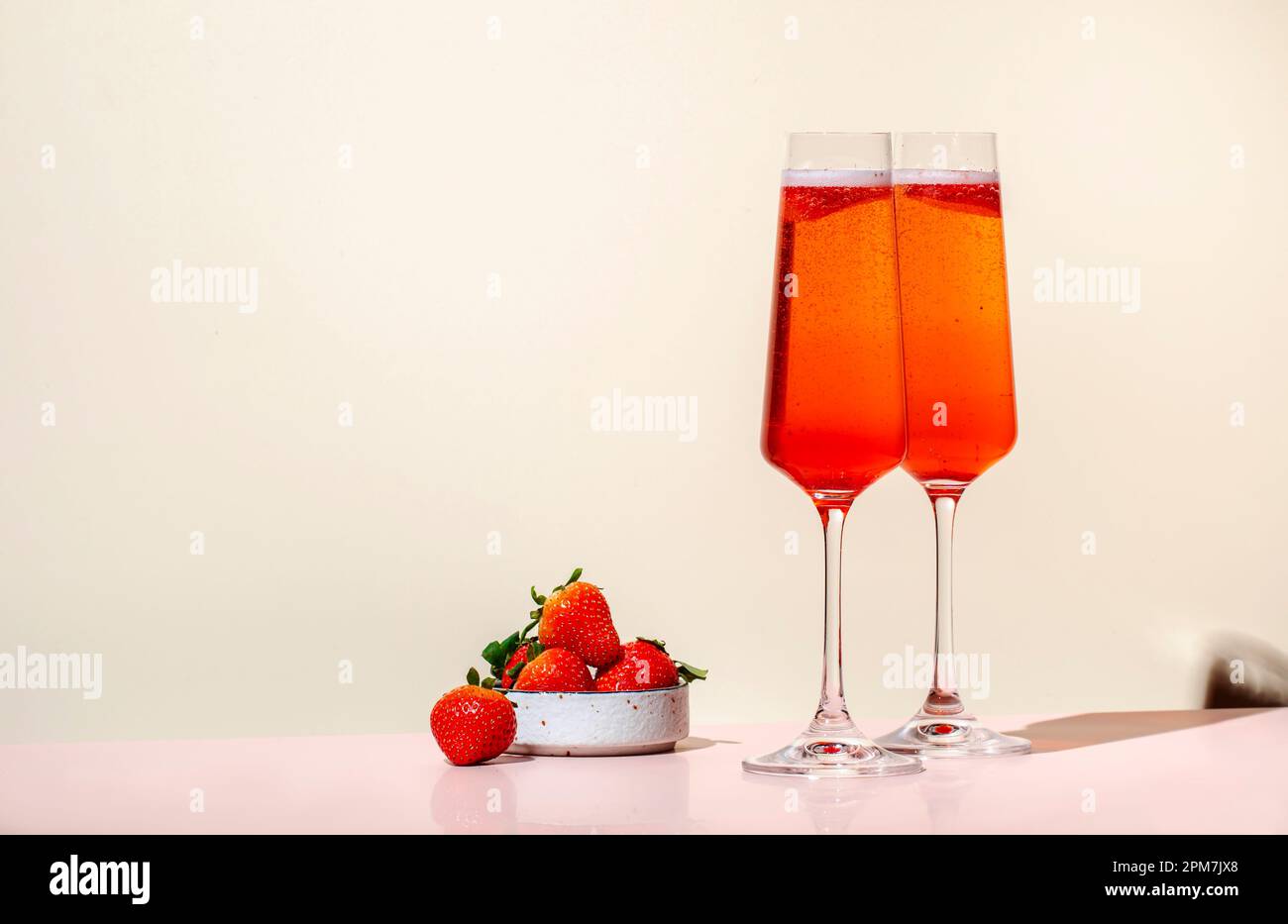 Rossini summer alcoholic cocktail drink with sparkling wine or prosecco, strawberry puree and ...