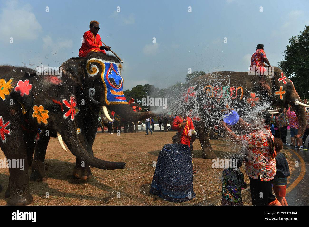 Ayutthaya, Thailand. 11th Apr, 2023. Elephants and tourists splash water on each other during a ...
