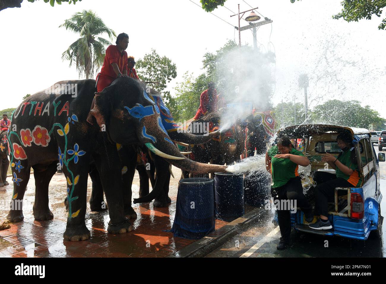 Ayutthaya, Thailand. 11th Apr, 2023. Elephants spray water on tourists during a celebration for ...