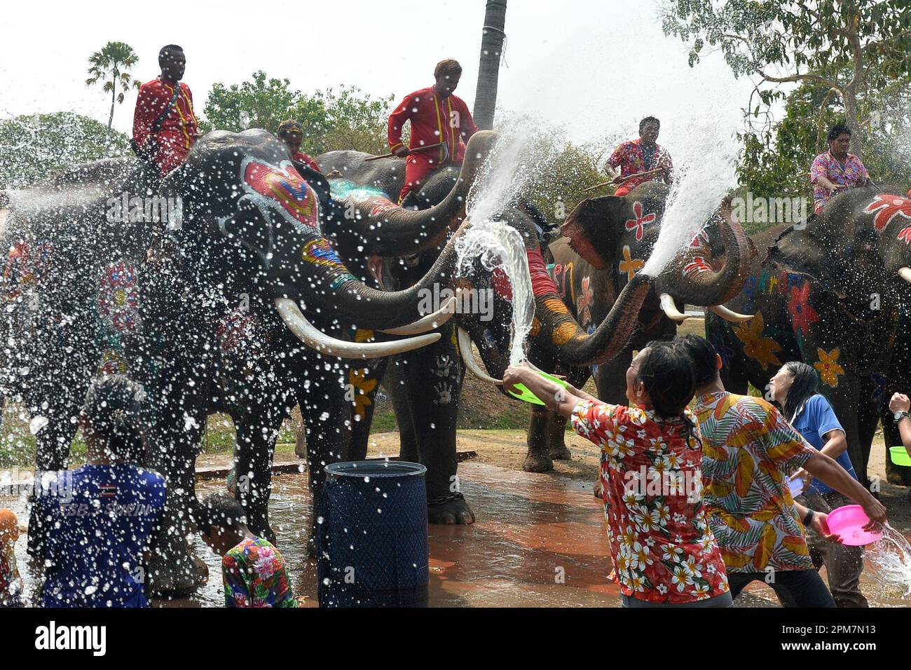 Ayutthaya, Thailand. 11th Apr, 2023. Elephants and tourists splash water on each other during a ...
