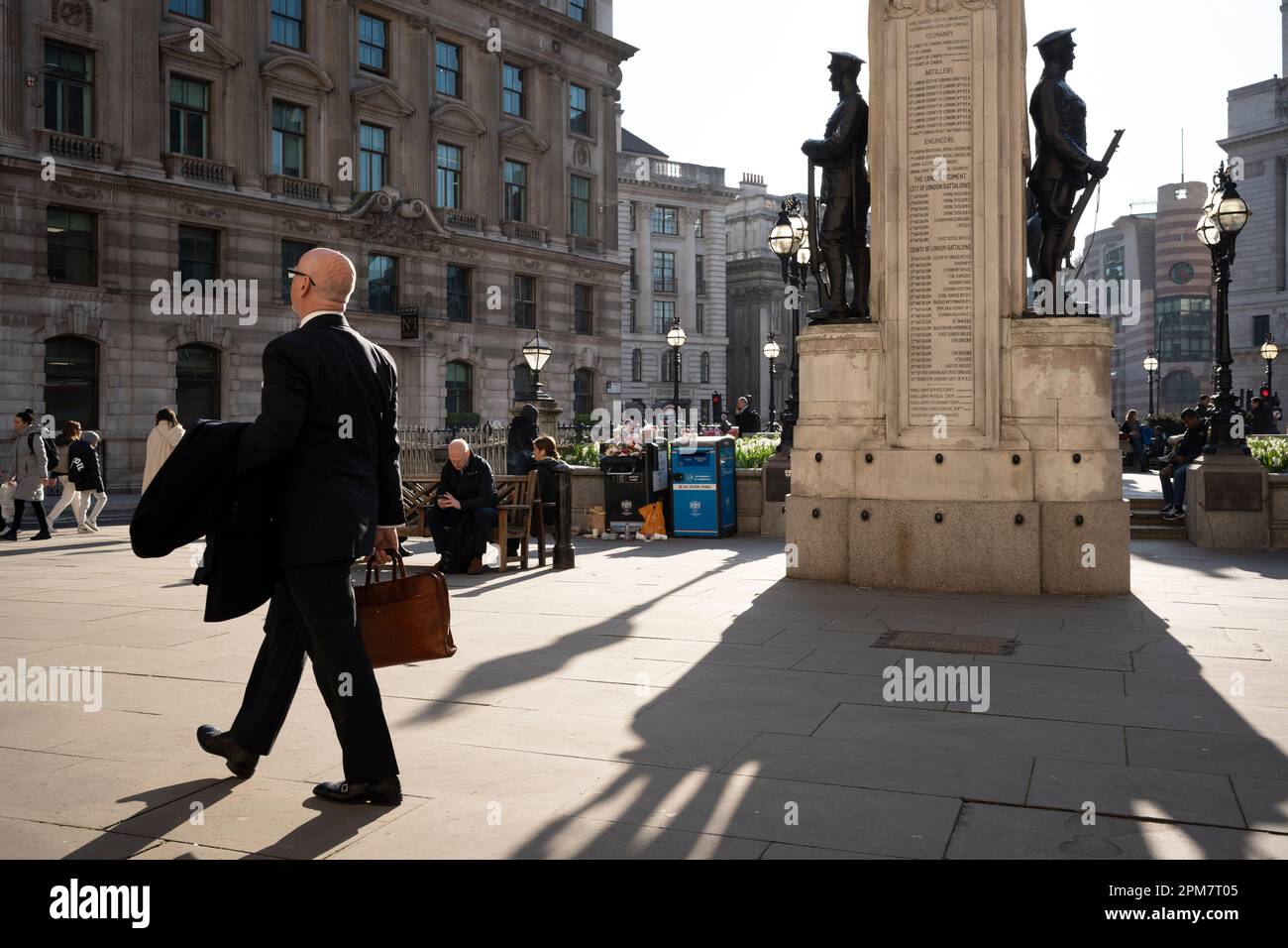 City workers and visitors to London walk past the war memorial to those ...