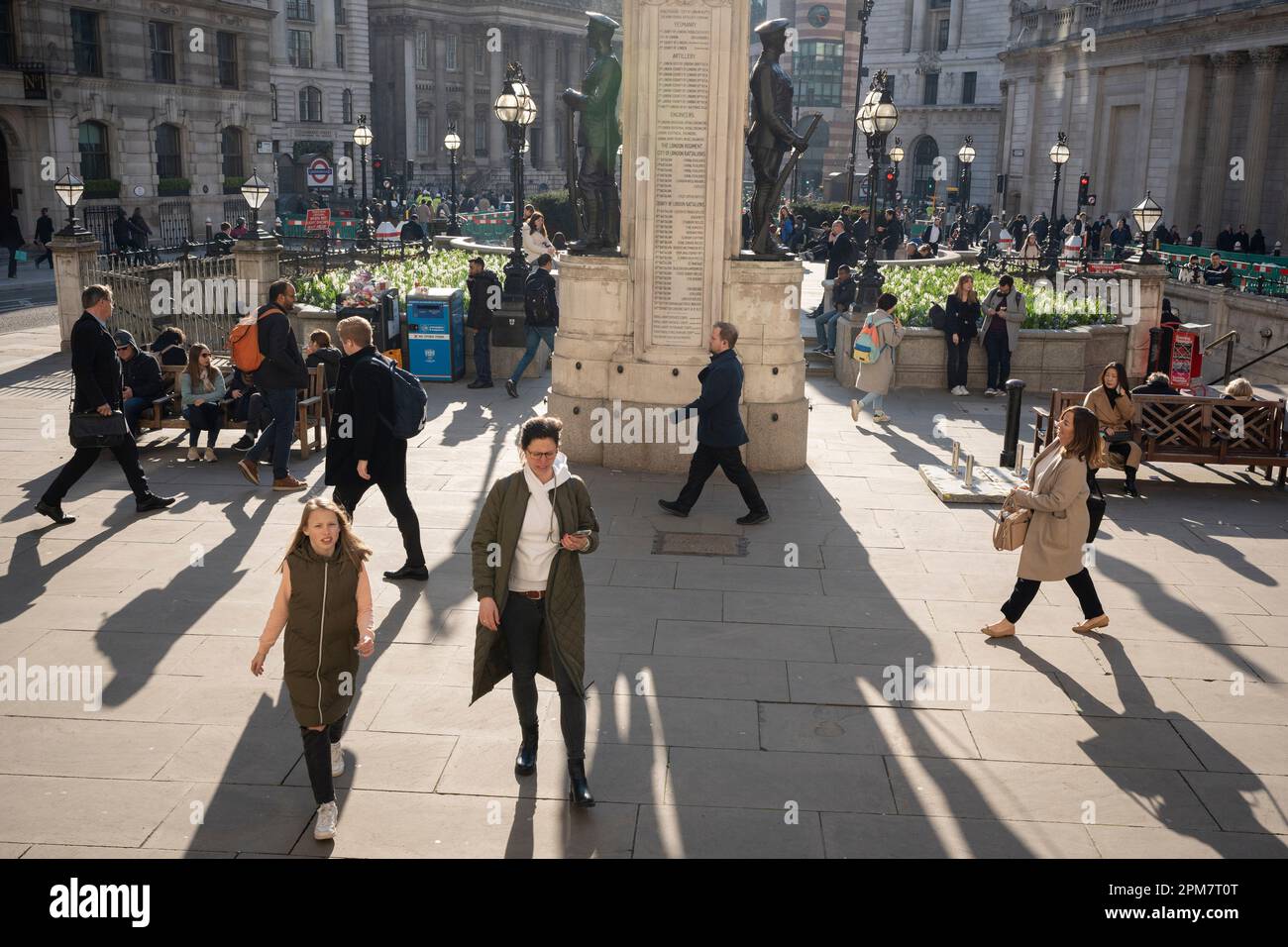 City workers and visitors to London walk past the war memorial to those ...