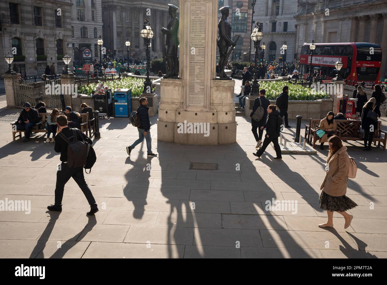 City workers and visitors to London walk past the war memorial to those ...
