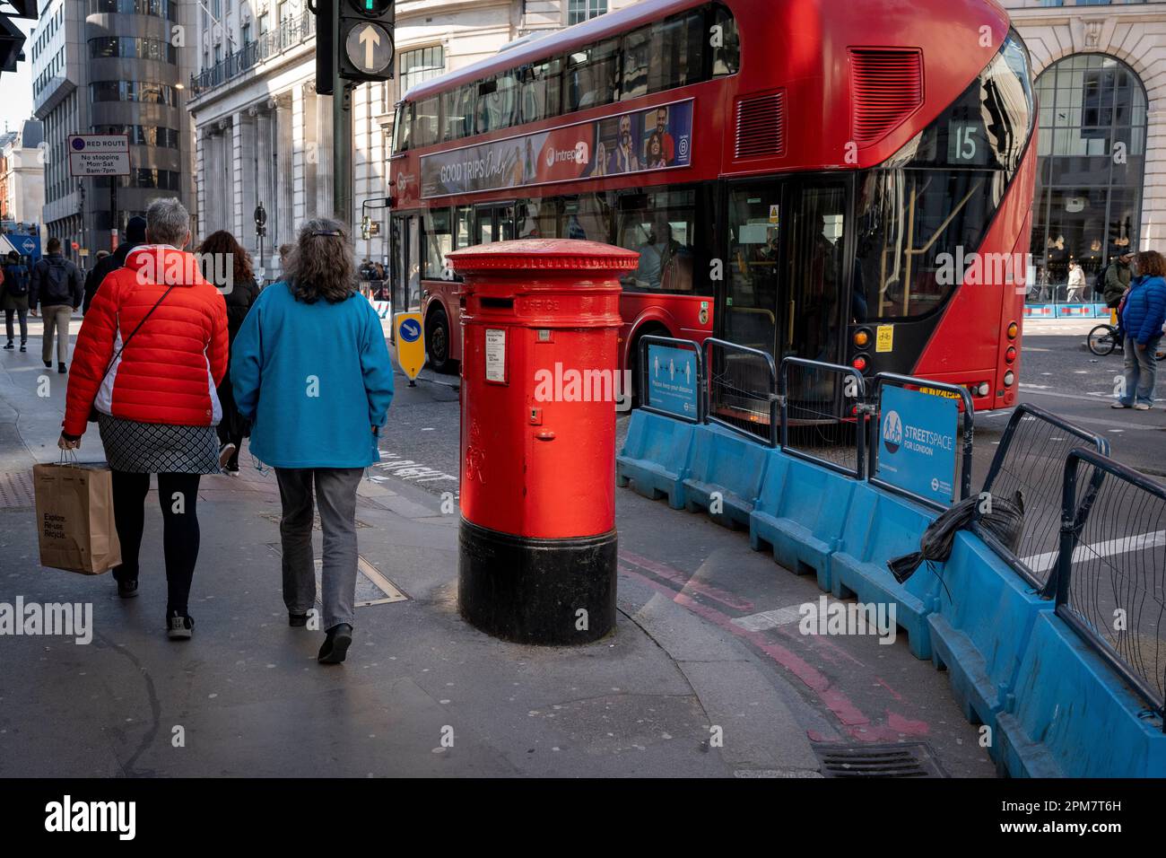 A street moment when pedestrians wearing red and blue alternate with an ...